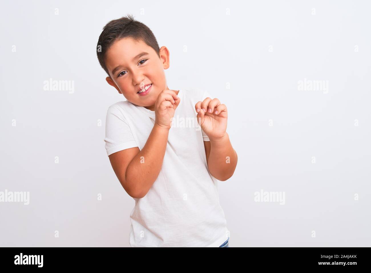 Beautiful kid boy wearing casual t-shirt standing over isolated white ...