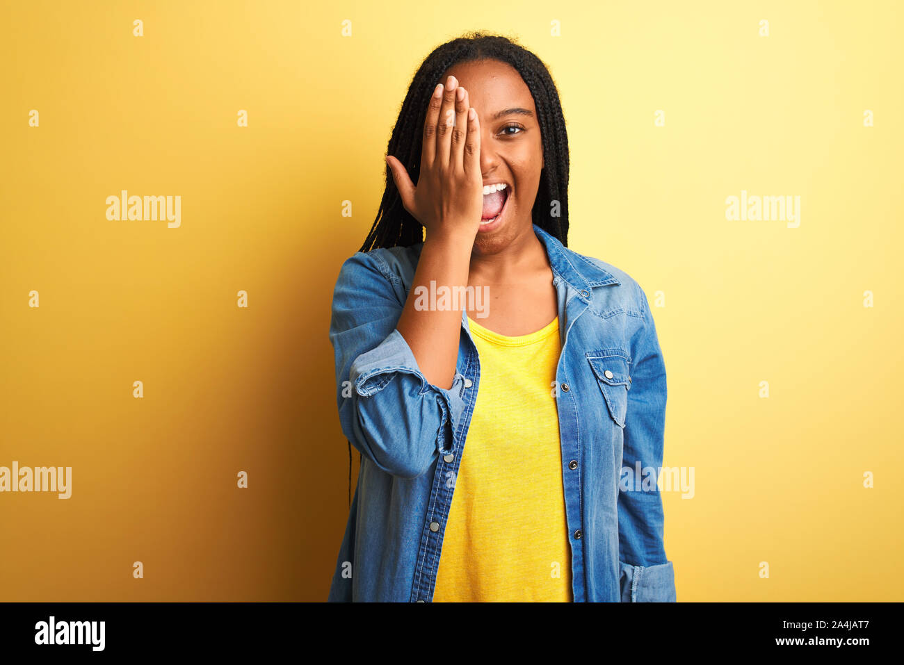 Young african american woman wearing denim shirt standing over isolated ...