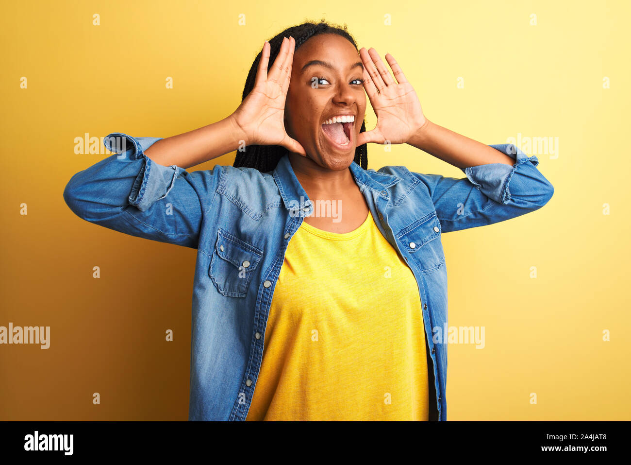 Young african american woman wearing denim shirt standing over isolated ...