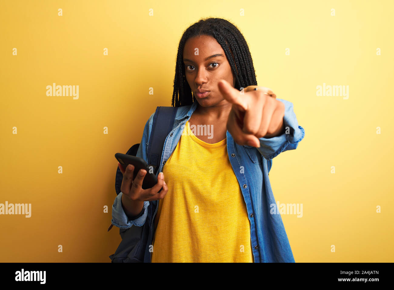 African american student woman using smartphone standing over isolated ...