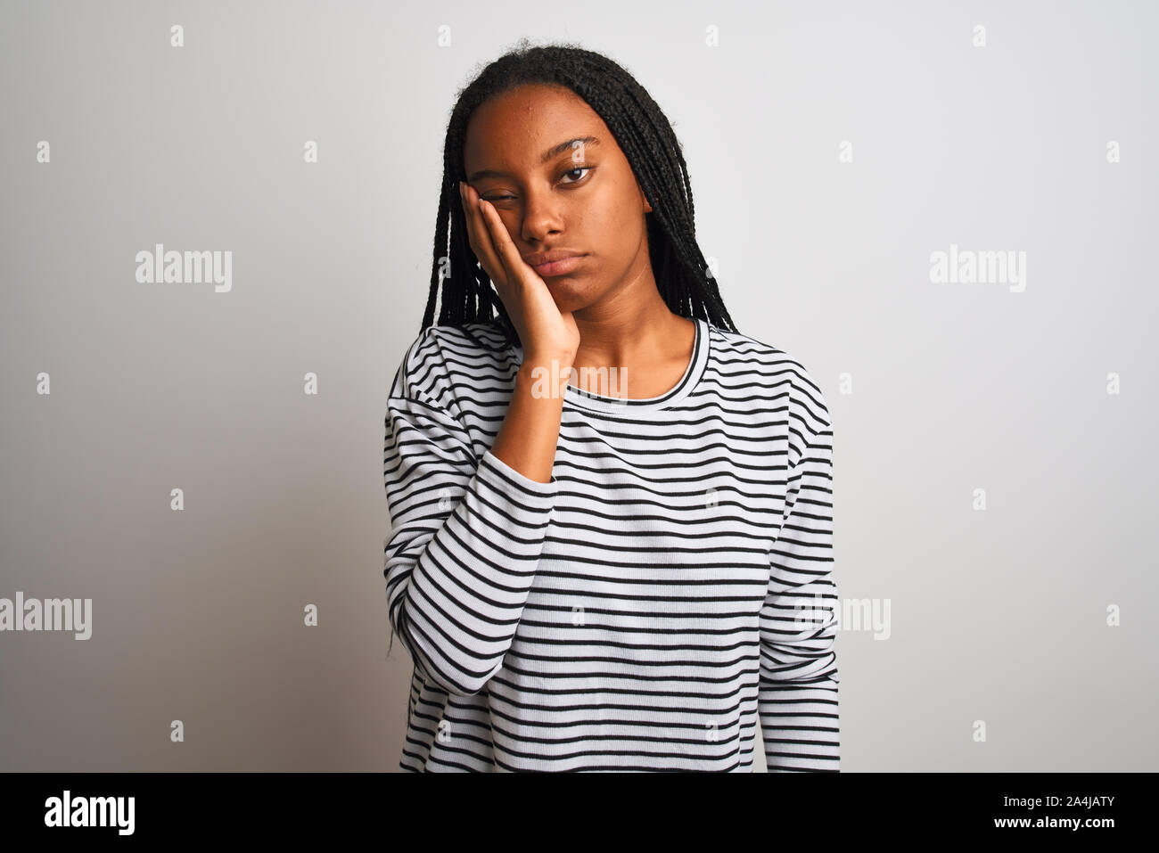 Young african american woman wearing striped t-shirt standing over ...