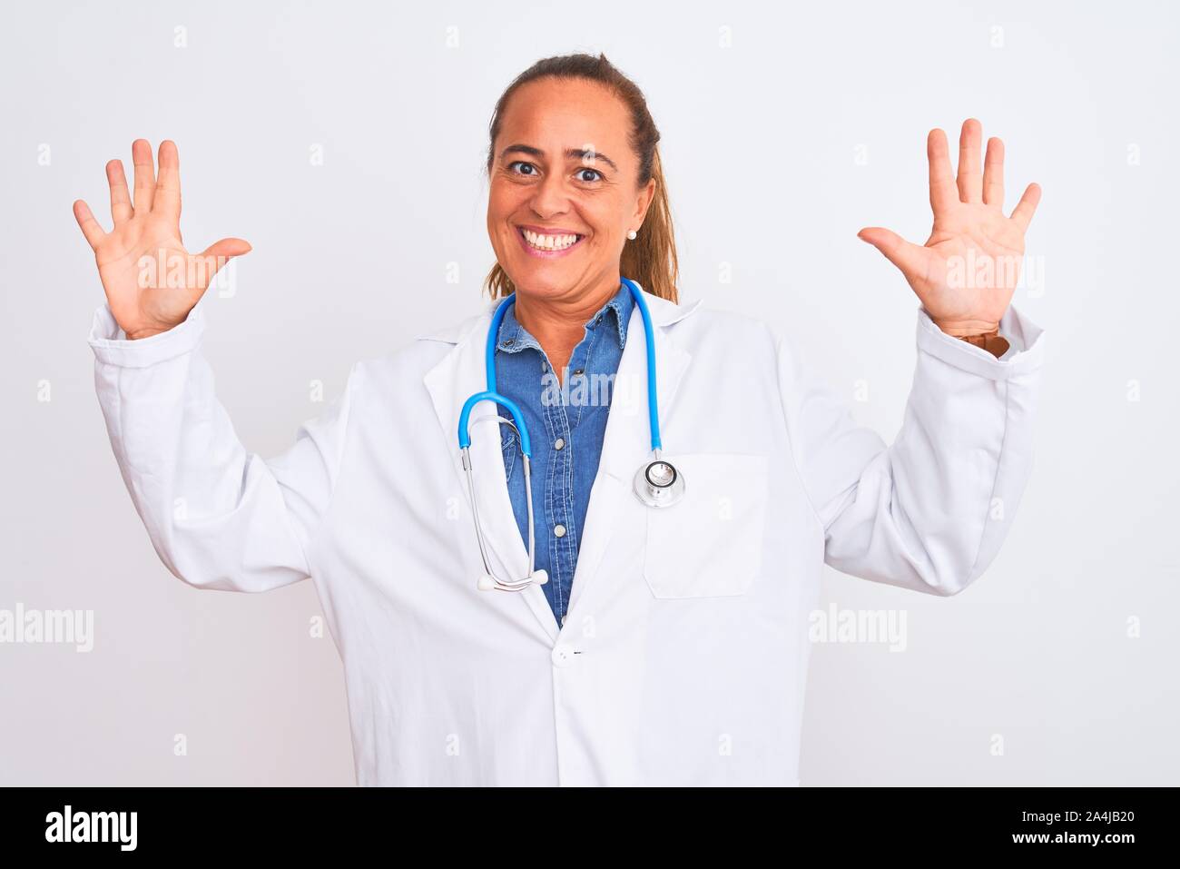Middle age mature doctor woman wearing stethoscope over isolated ...