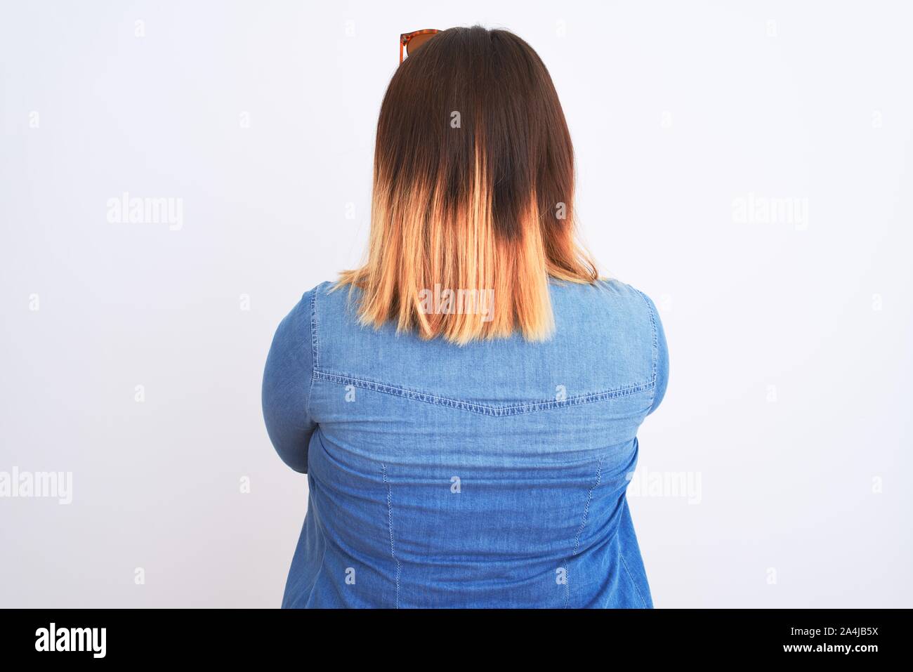 Beautiful woman wearing denim shirt standing over isolated white ...
