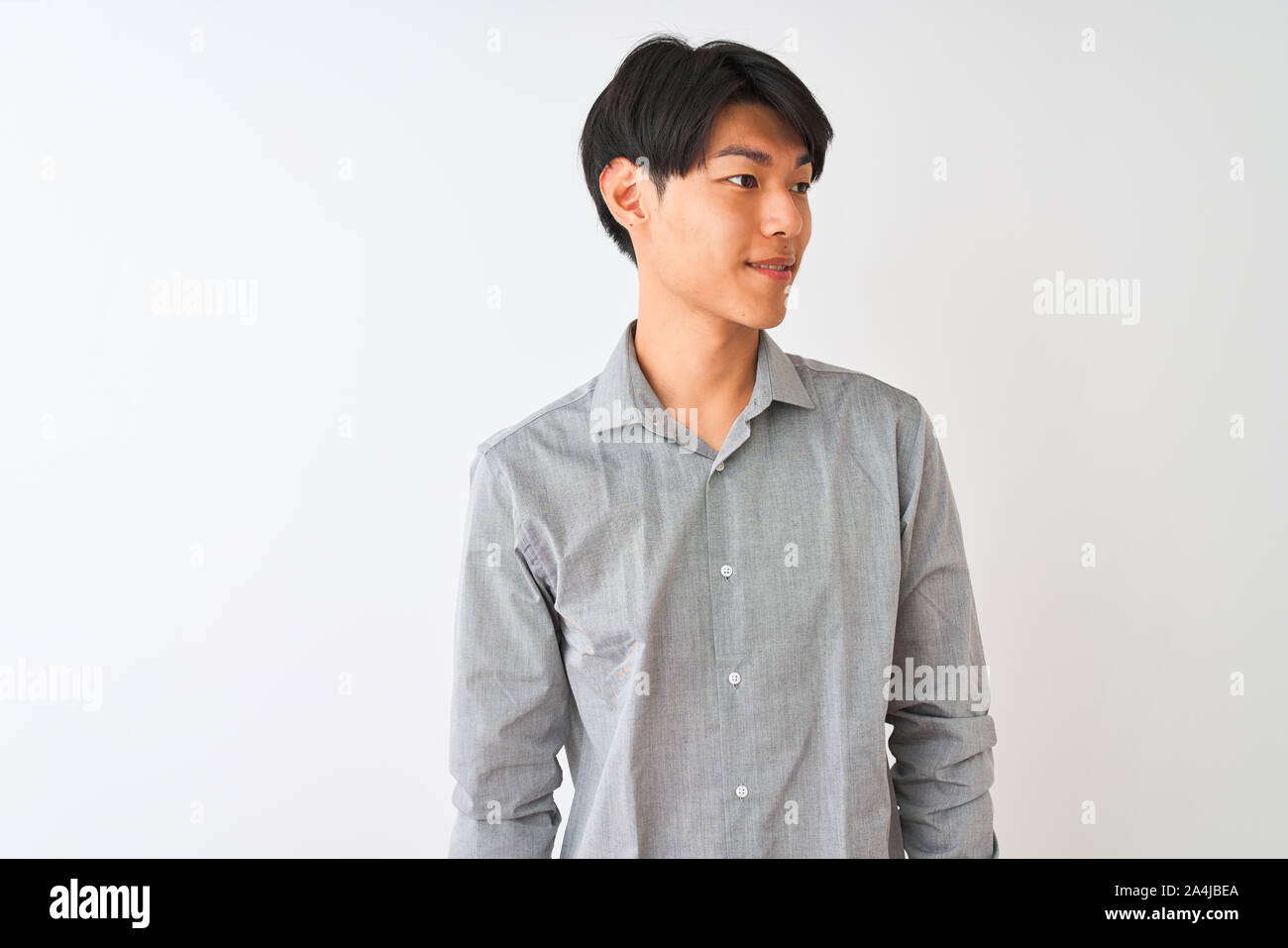 Chinese businessman wearing elegant shirt standing over isolated white ...