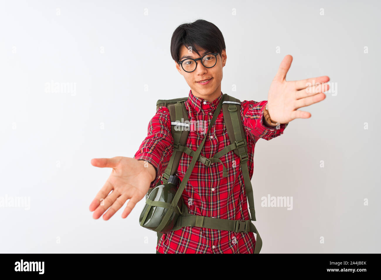 Chinese hiker man wearing backpack canteen glasses over isolated white ...
