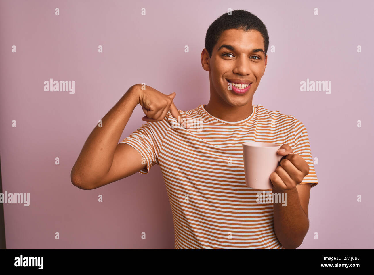 Handsome Arab Man Wearing Striped T Shirt Drinking Coffee Over Isolated