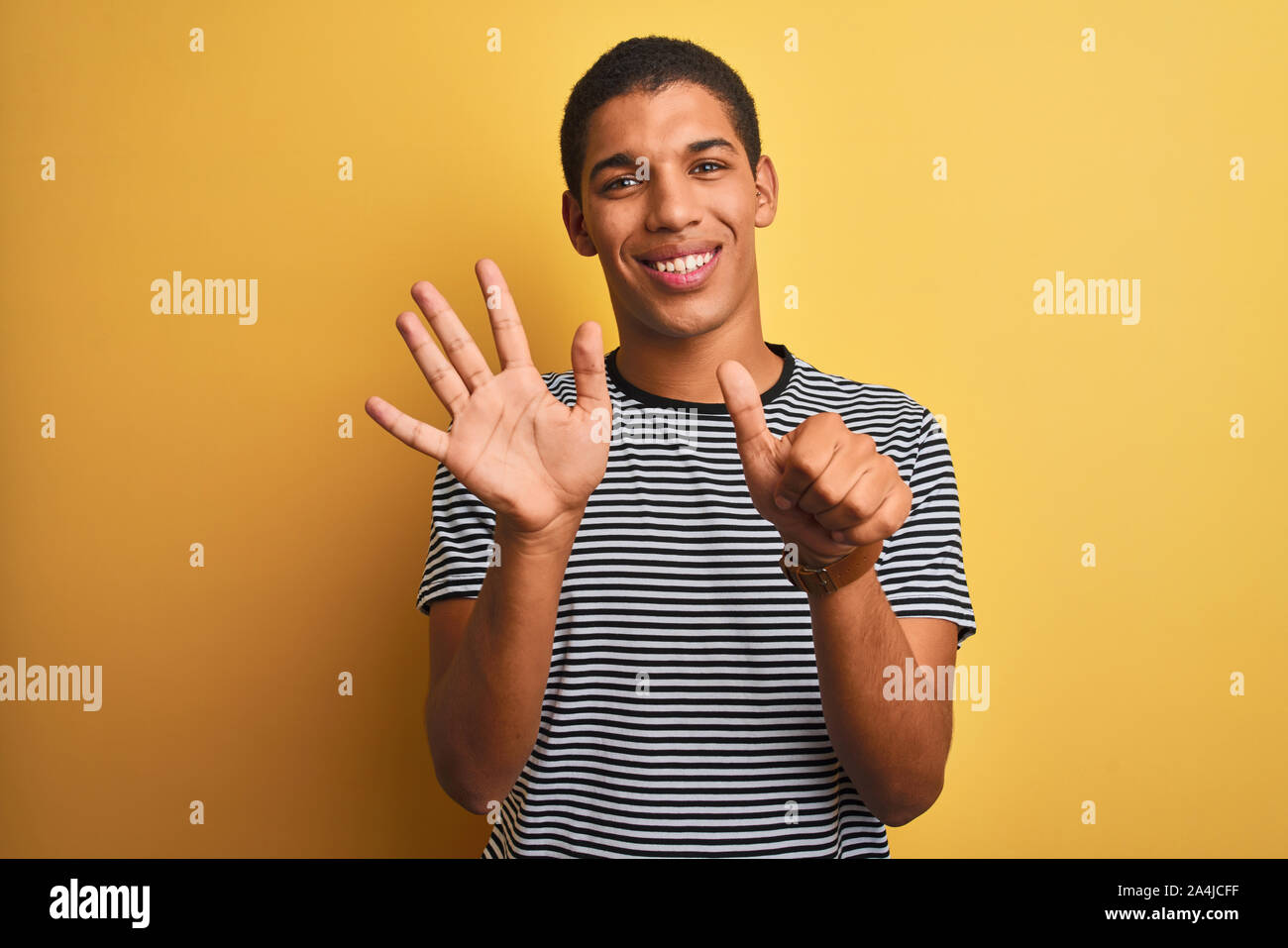 Young handsome arab man wearing navy striped t-shirt over isolated ...