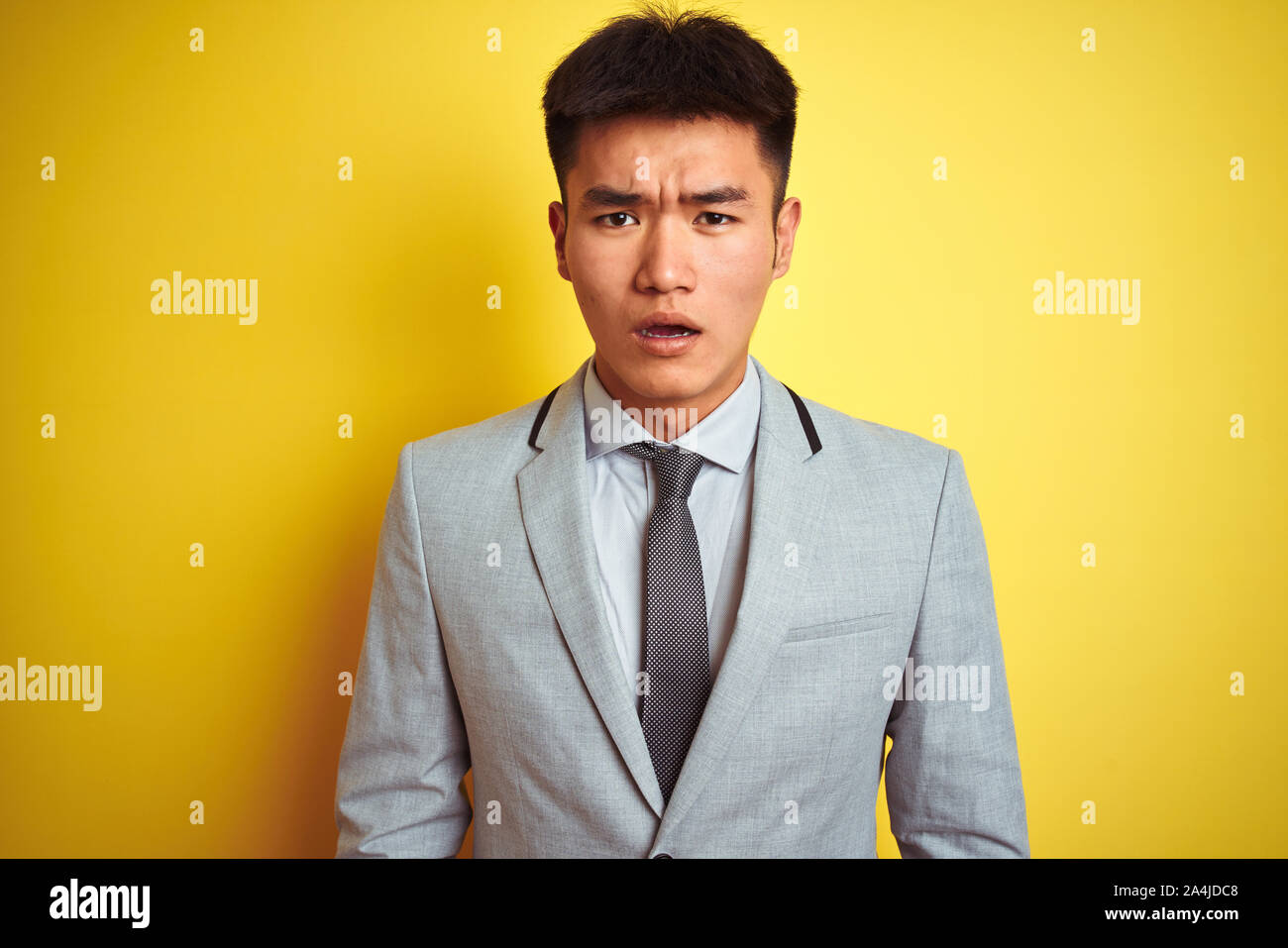 Asian chinese businessman wearing suit and tie standing over isolated ...