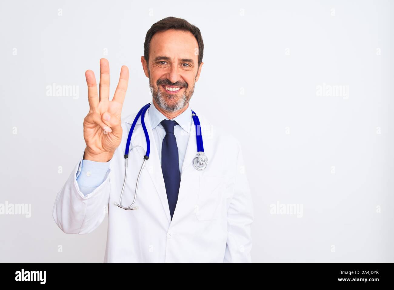 Middle age doctor man wearing coat and stethoscope standing over ...