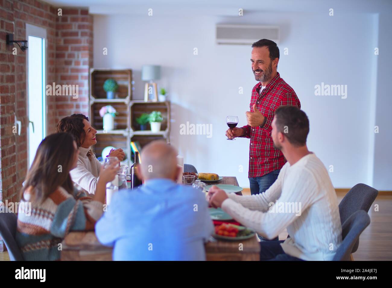 Beautiful family smiling happy and confident. Man speaking speech with ...