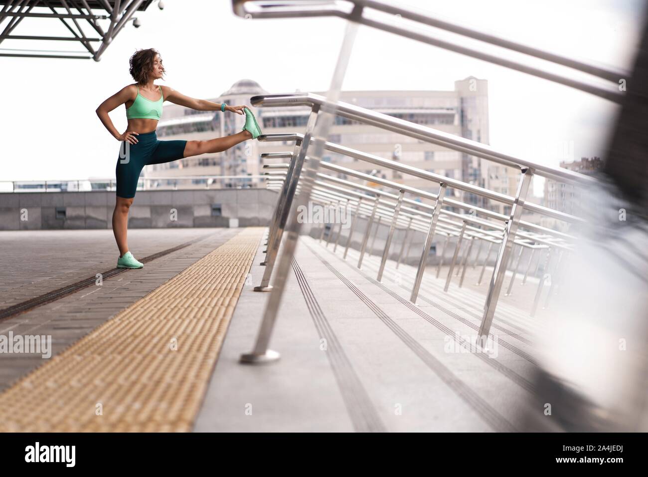 woman runner stretching leg muscle before running outdoors for athlete ...
