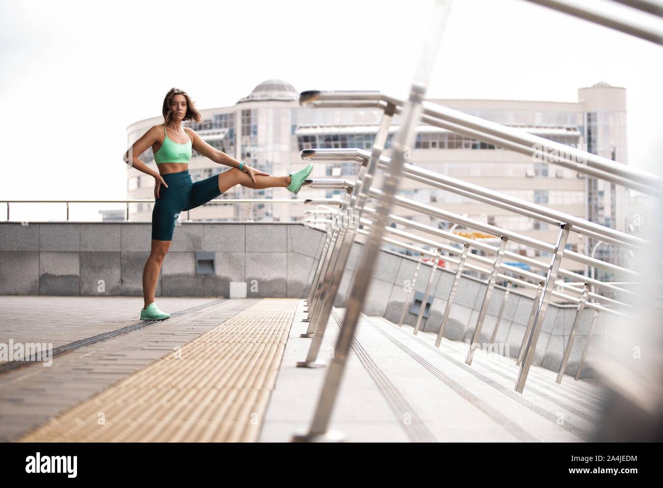 woman runner stretching leg muscle before running outdoors for athlete ...