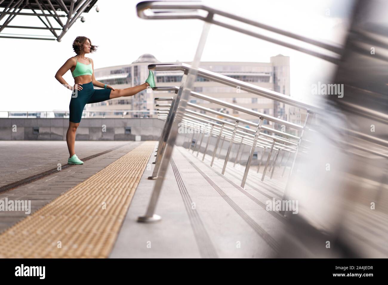 woman runner stretching leg muscle before running outdoors for athlete ...