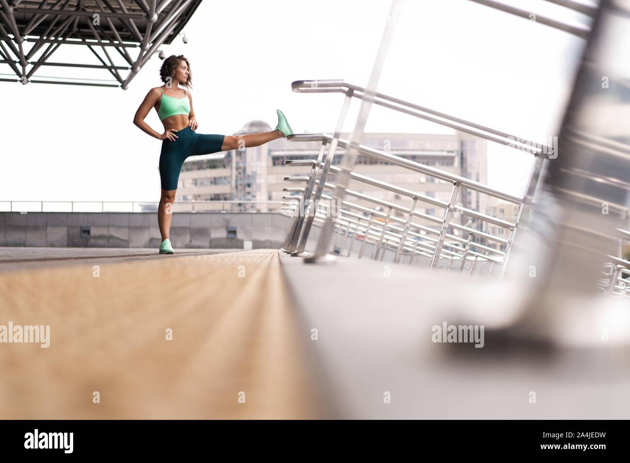 woman runner stretching leg muscle before running outdoors for athlete ...