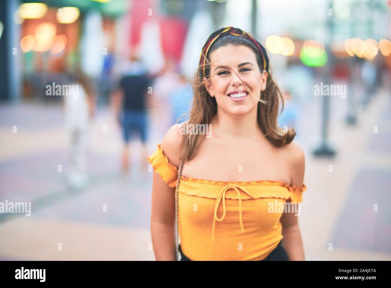 Young beautiful girl smiling happy and confident walking at the town ...