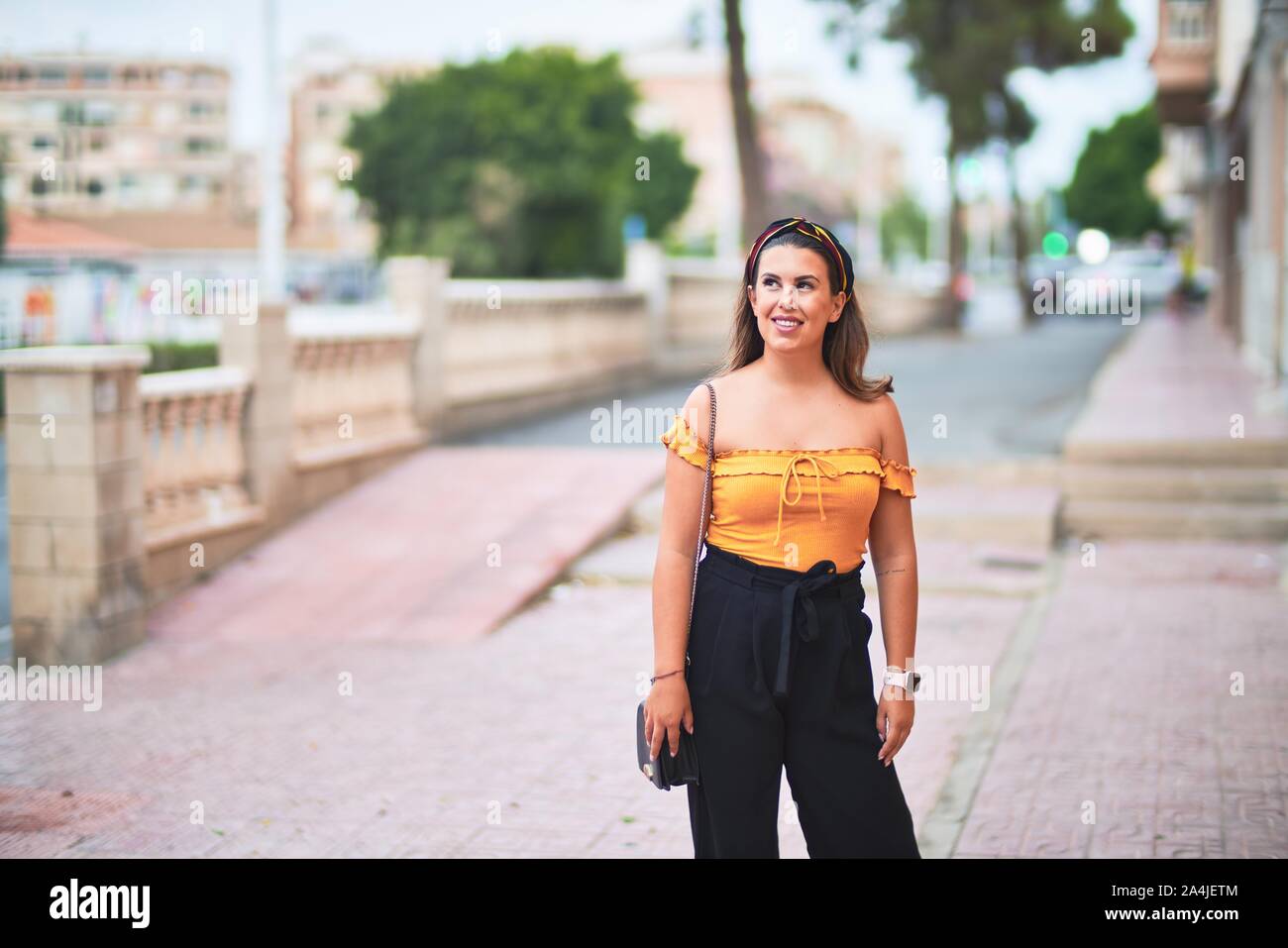 Young beautiful girl smiling happy and confident walking at the town ...