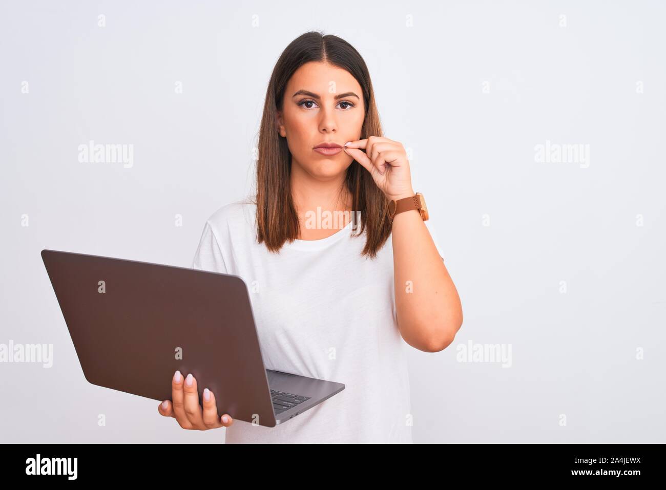 Beautiful young woman working using computer laptop over white ...