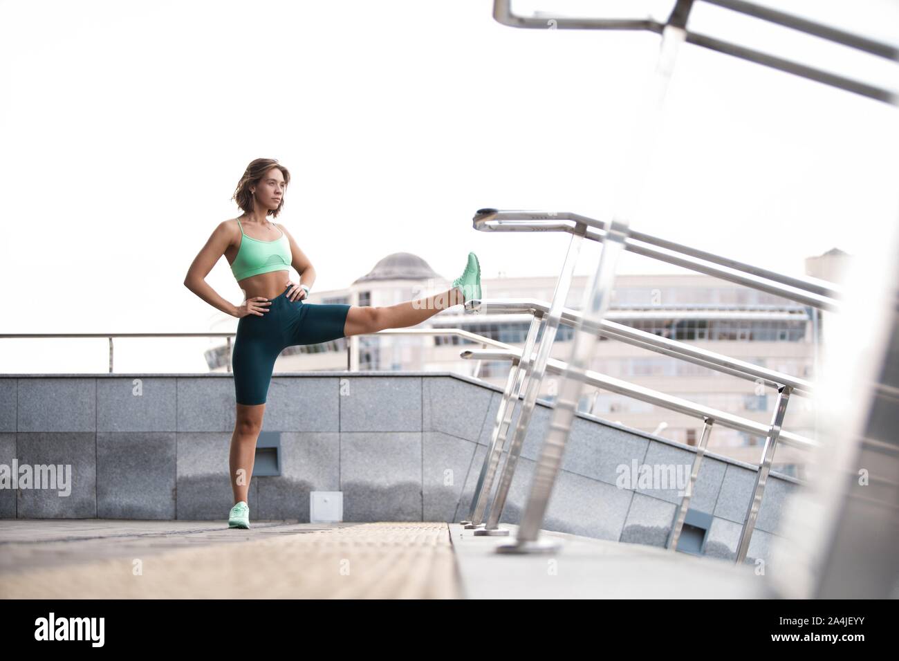 woman runner stretching leg muscle before running outdoors for athlete ...
