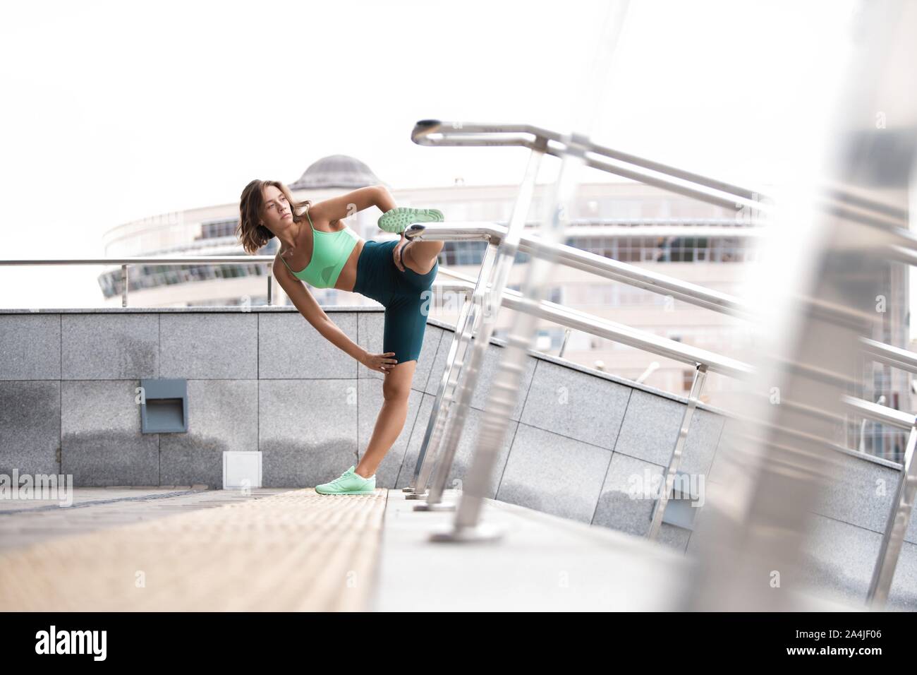 woman runner stretching leg muscle before running outdoors for athlete ...