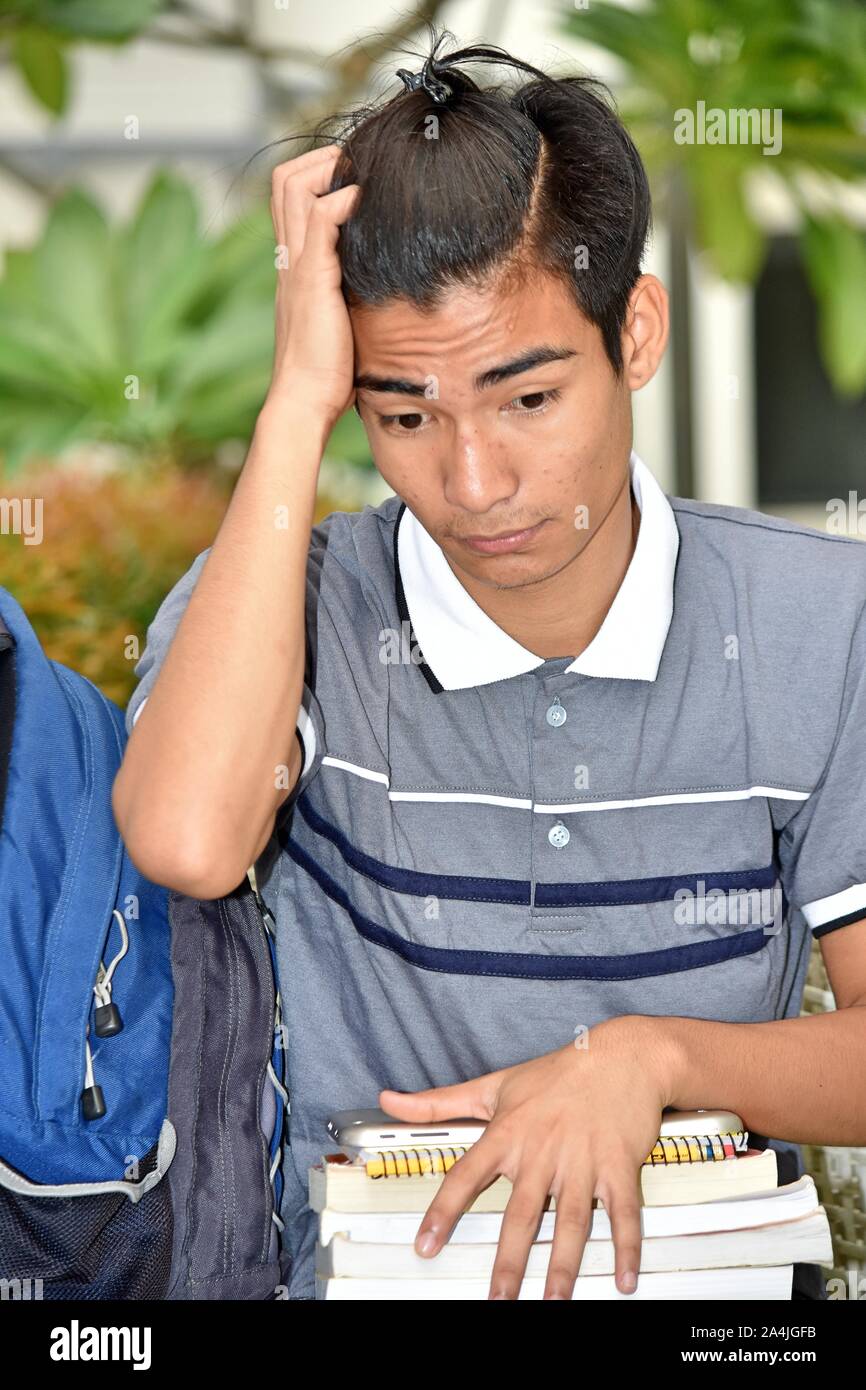 Young Filipino Student Under Stress With Notebooks Stock Photo - Alamy
