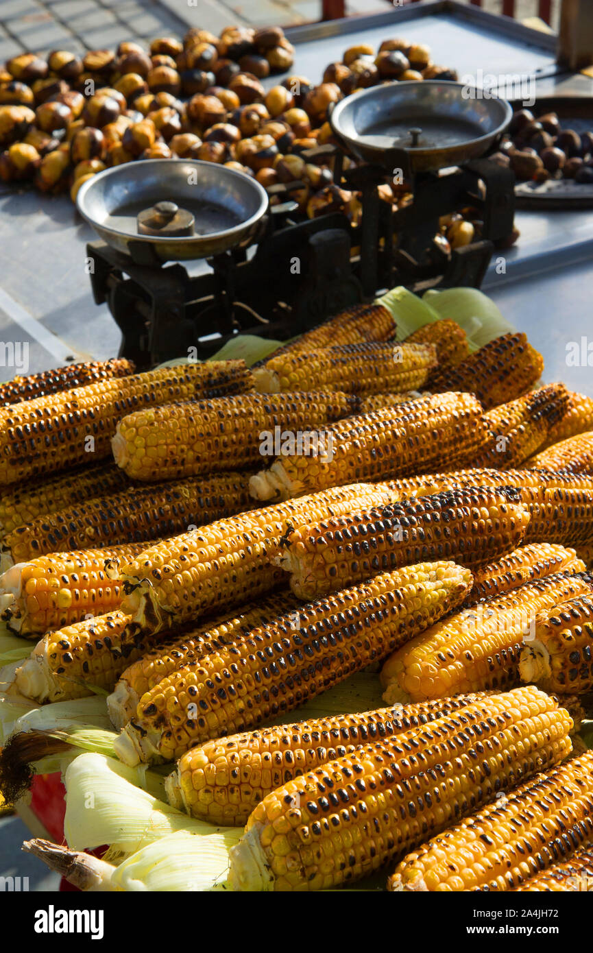Still life of roasted corn cobs and old iron scale Stock Photo - Alamy
