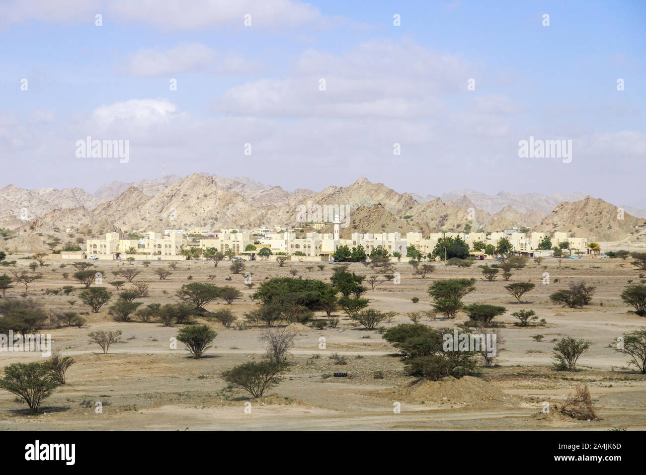Small modern city in the United Arab Emirates in the desert at the foot ...