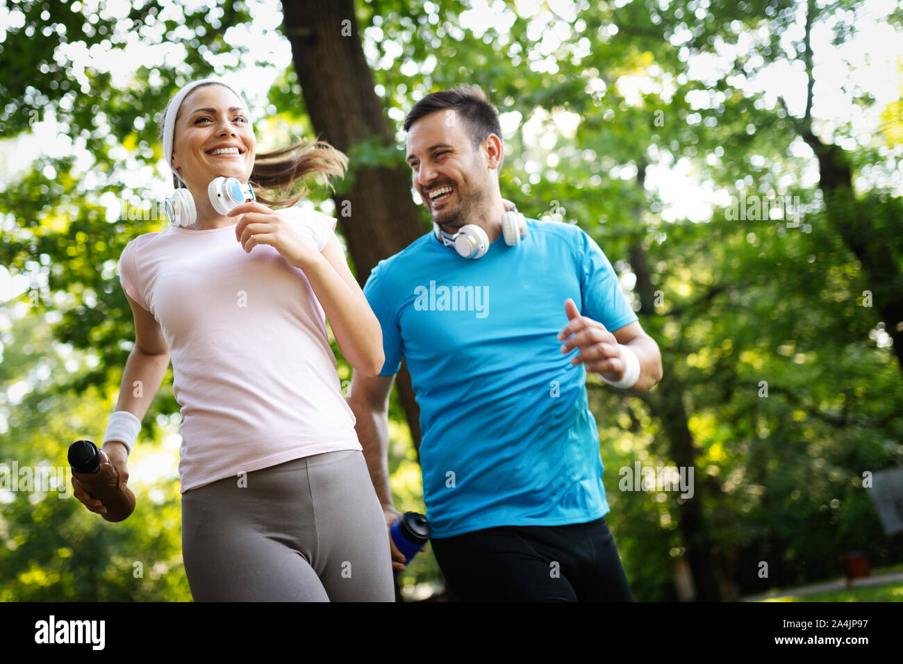 Sportive couple running in forest hi-res stock photography and images ...