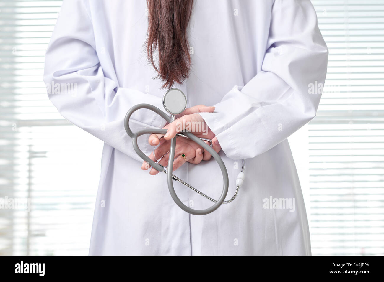 Doctor holding stethoscope behind back hi-res stock photography and ...