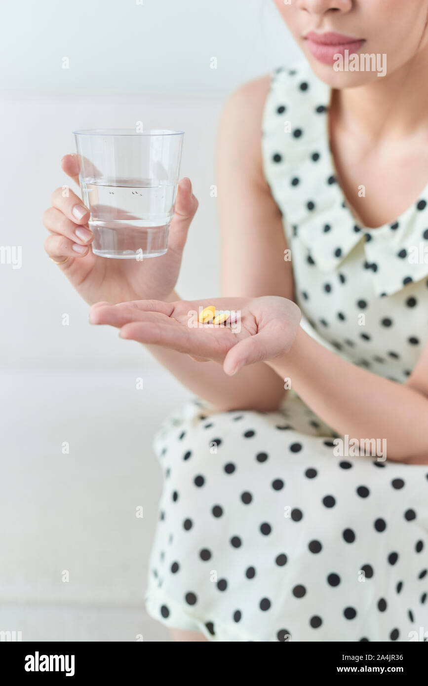 Young happy woman taking pills hi-res stock photography and images - Alamy