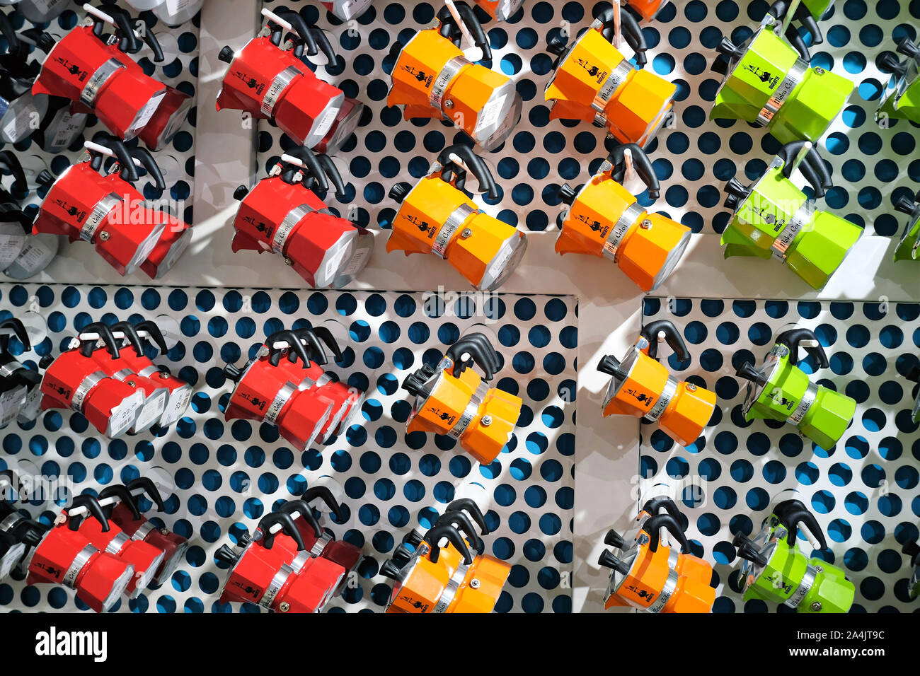 colorful italian moka pots coffee makers hanging on the wall in a shop ...