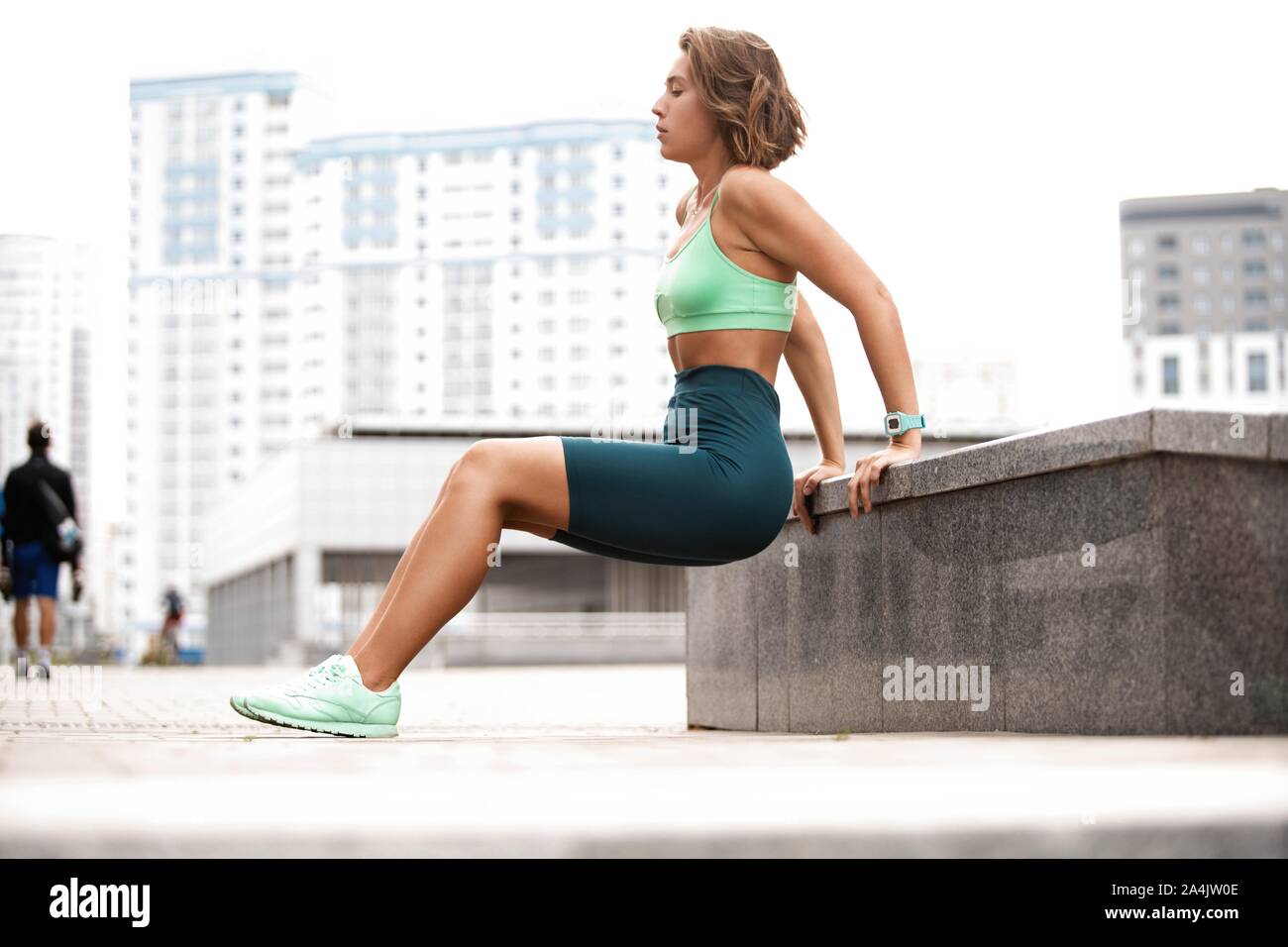 Woman exercising working out triceps and biceps doing dips Stock Photo ...