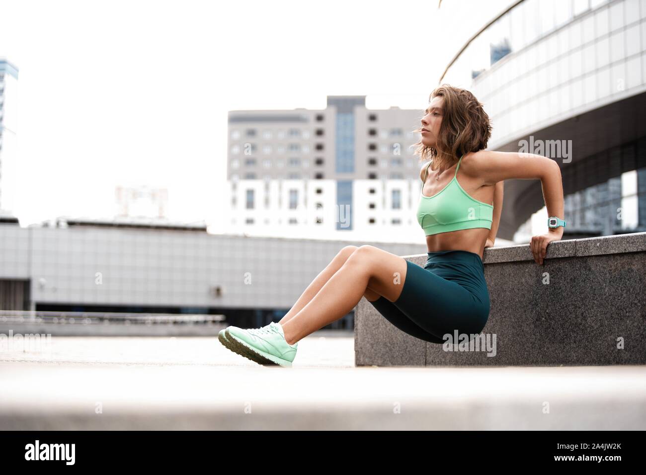 Woman exercising working out triceps and biceps doing dips Stock Photo ...