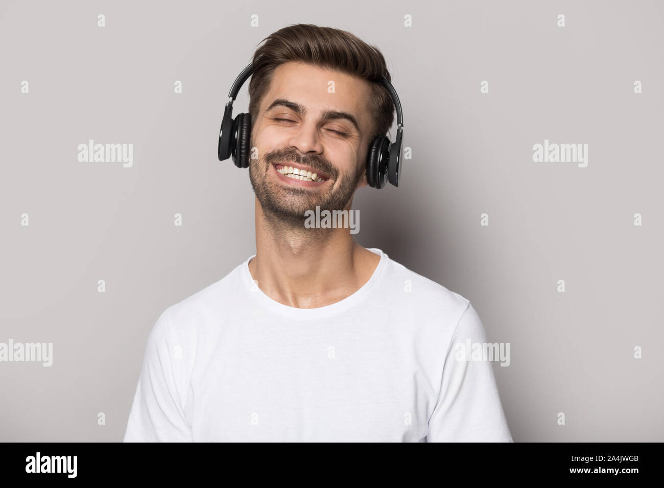 Happy caucasian man listen to music in Bluetooth headphones Stock Photo ...