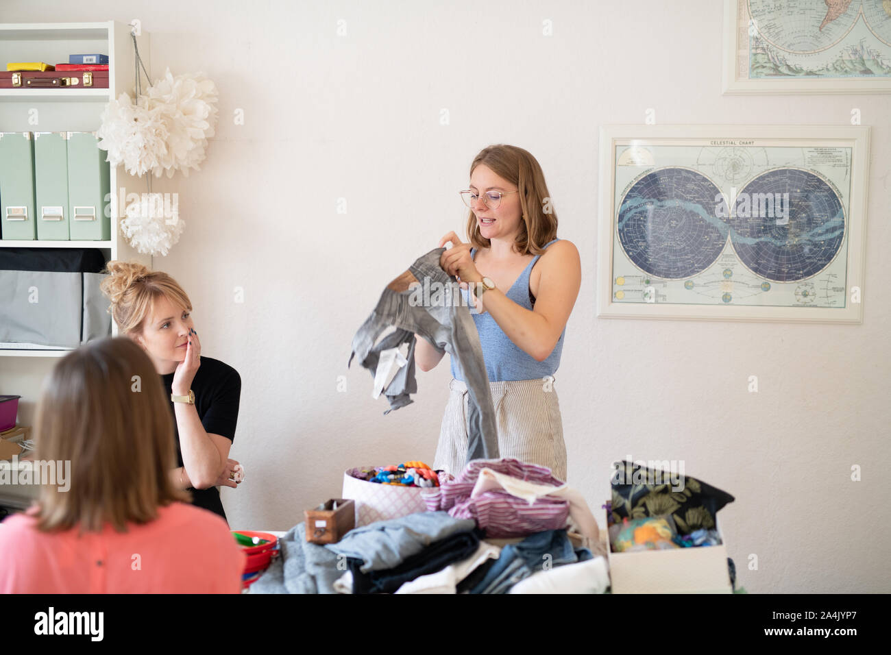teacher instructing students at embroidery and recycled material class ...