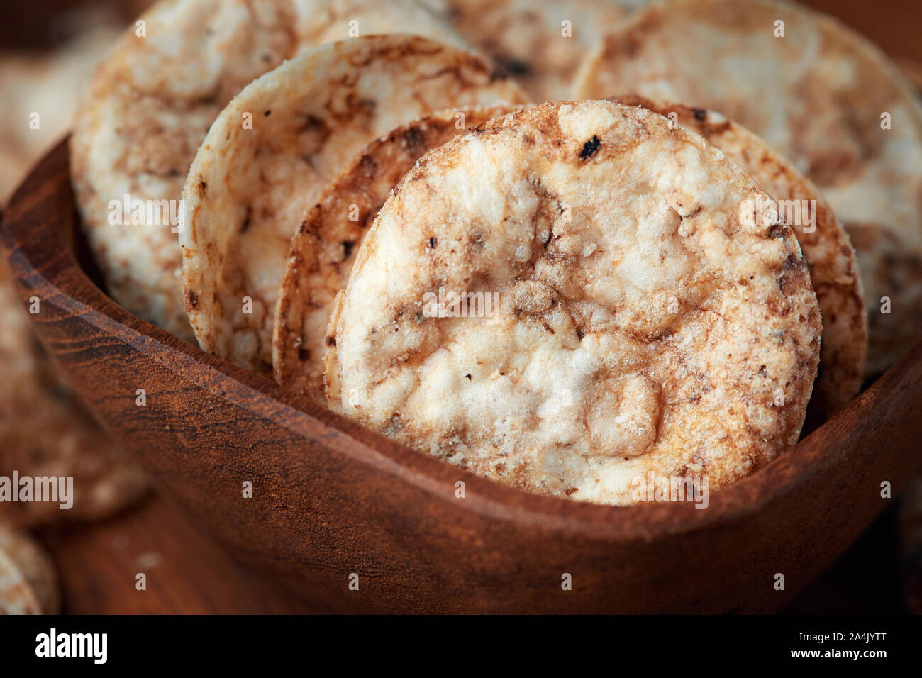 Brown rice chips in wooden bowl. Healthy crispy snack Stock Photo - Alamy