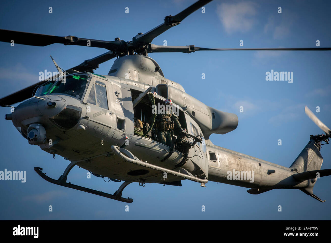 A U.S. Marine Corps Reserve UH-1Y Venom helicopter crew chief with ...