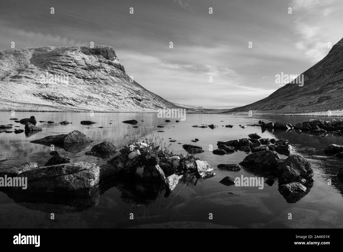 Snowy mountains at a cold lake Stock Photo - Alamy