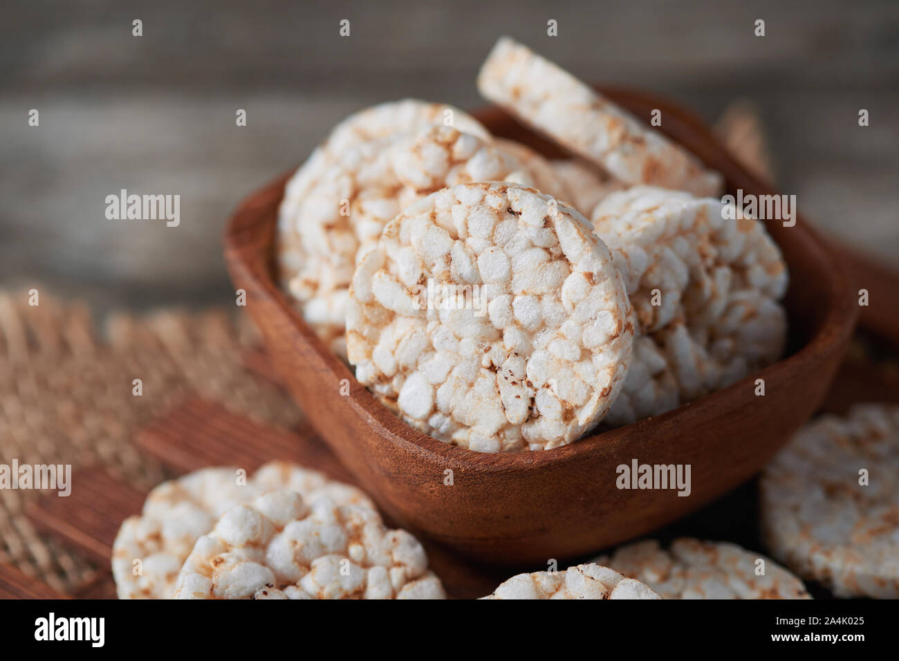 Round crispy rice crackers (cakes) served in wooden bowl Stock Photo ...