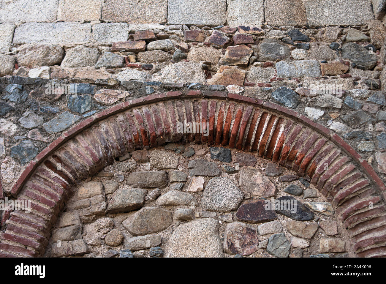 Ancient bricks forming a support arch in an access to an ancient Roman ...
