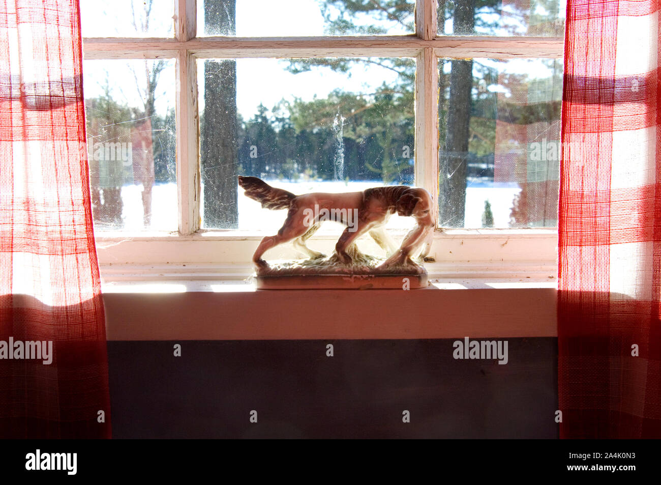 Porcelain dog in window sill Stock Photo - Alamy