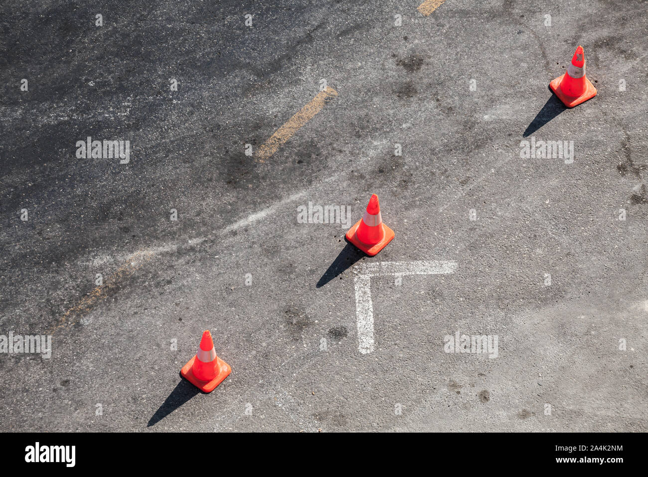 Three red warning road cones stand in line on an urban ground Stock ...