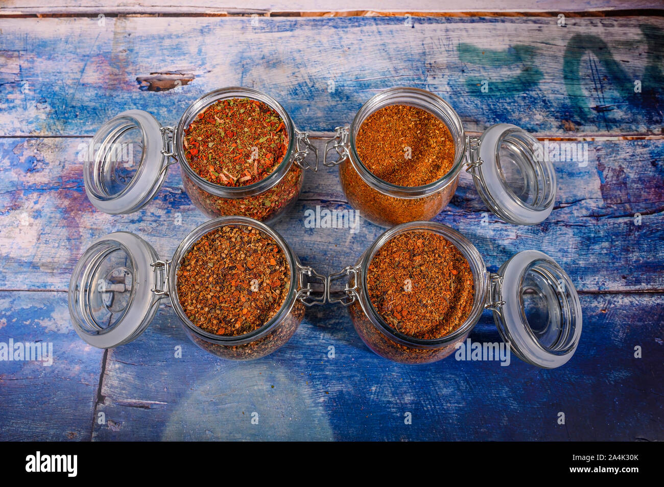 Fragrant spices in a glass jar with a lid and a metal lock on a wooden ...