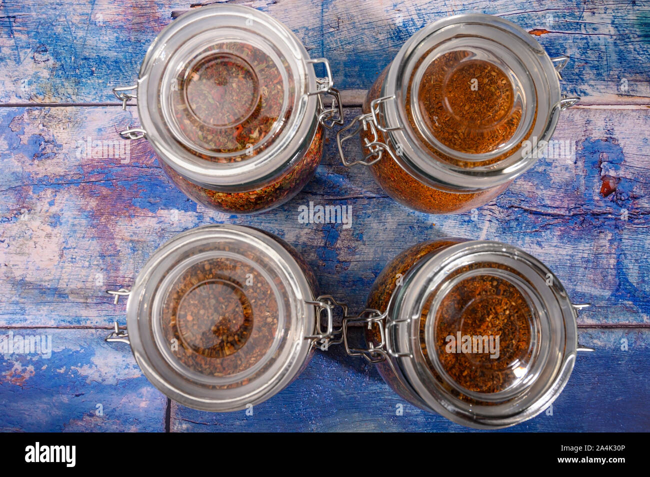 Fragrant spices in a glass jar with a lid and a metal lock on a wooden ...