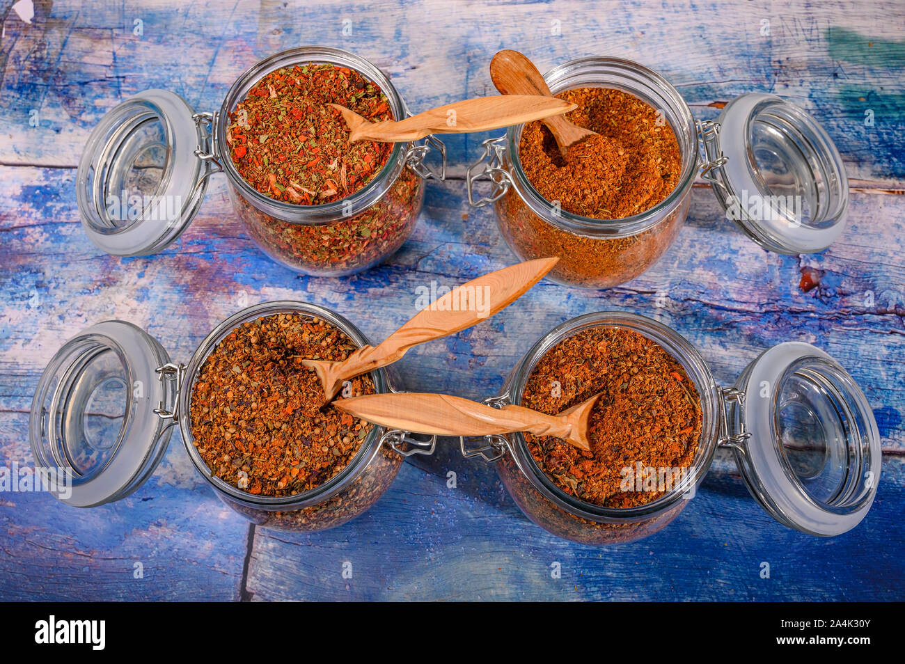 Fragrant spices in a glass jar with a lid and a metal lock on a wooden ...