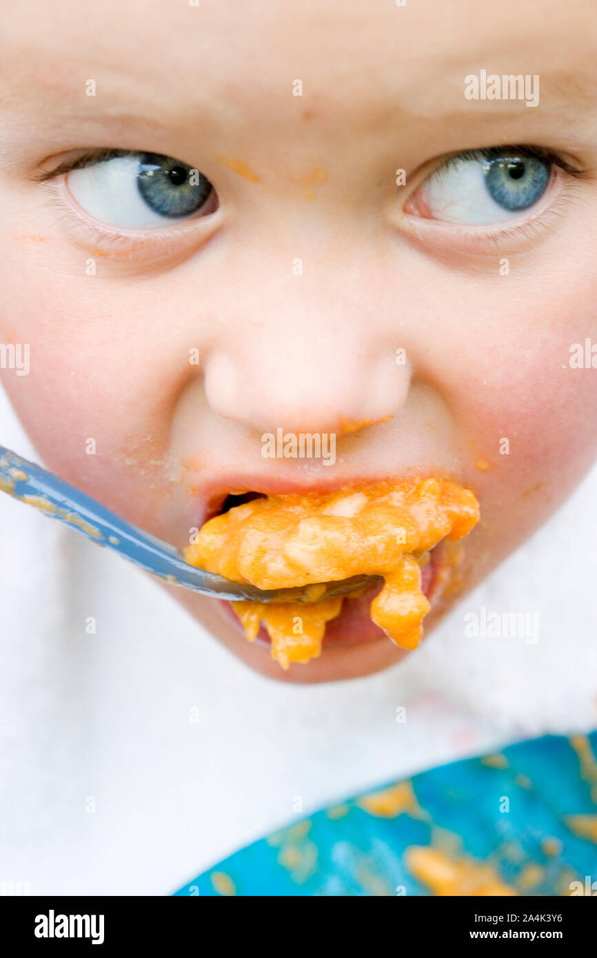 Feeding hungry child with babyfood Stock Photo - Alamy