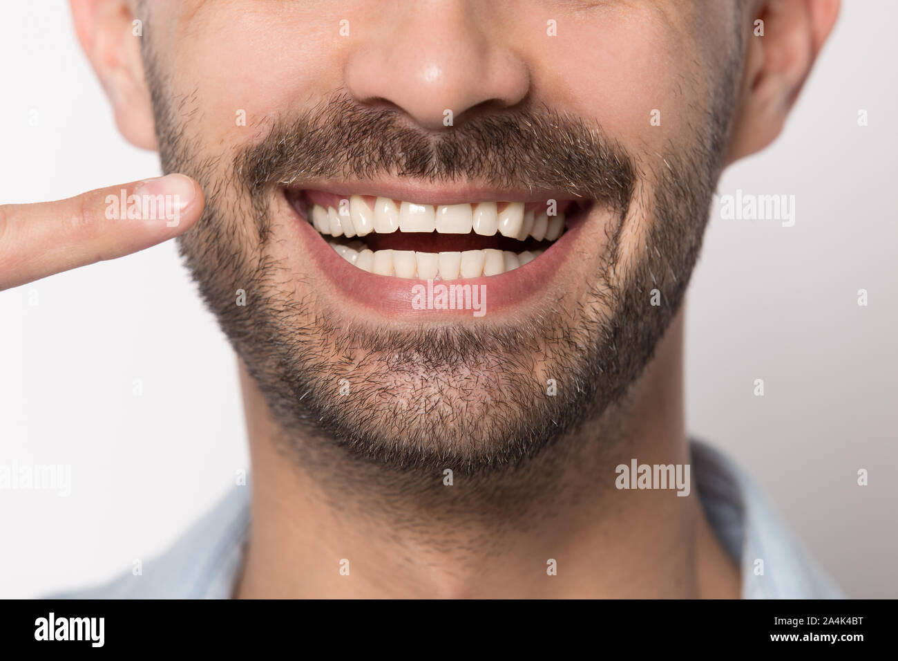 Close up of smiling man showing white healthy teeth Stock Photo - Alamy