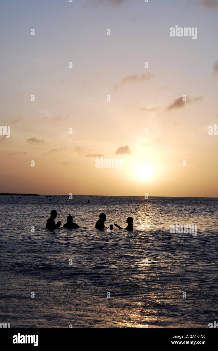 People bathing at sunset Stock Photo - Alamy