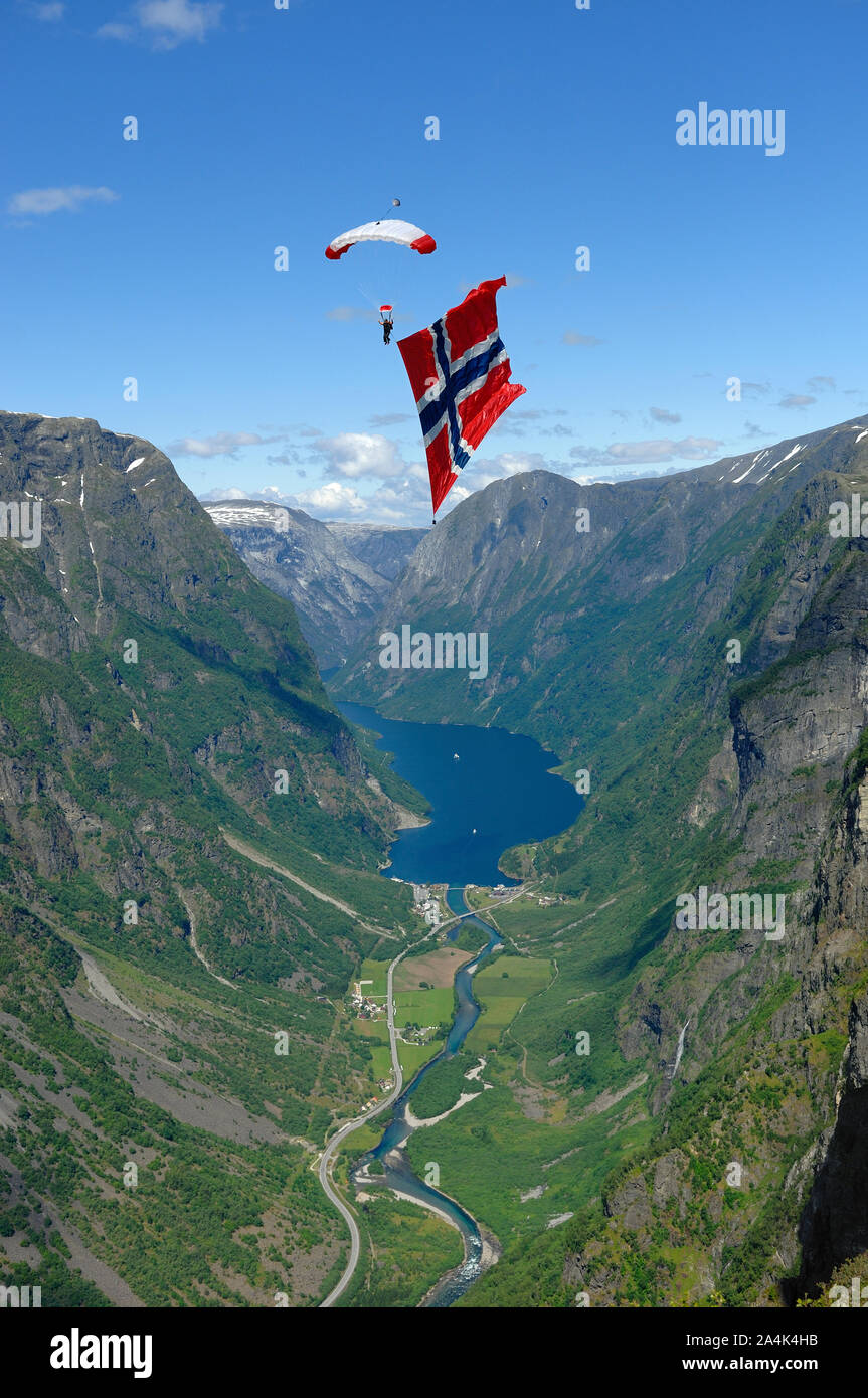 Unknown athlete skydiving with norwegian flag from Nebbet in Gudvangen ...