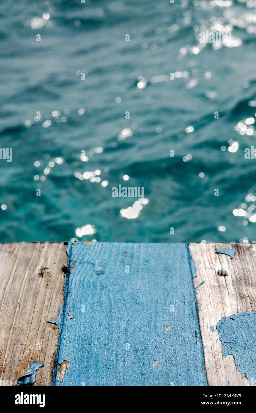 Blue painted pier and sea Stock Photo - Alamy