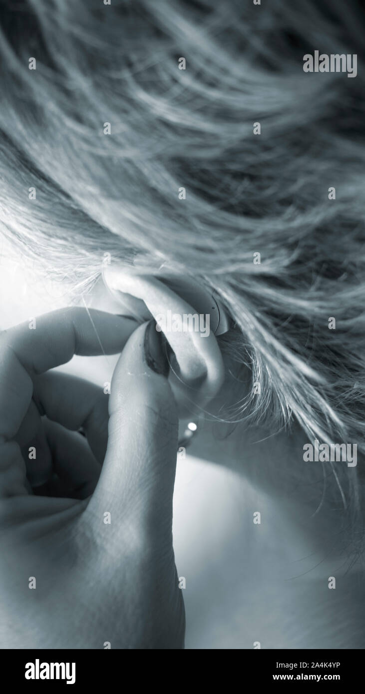 Deaf lady with modern technology digital hearing aid in her ear Stock ...